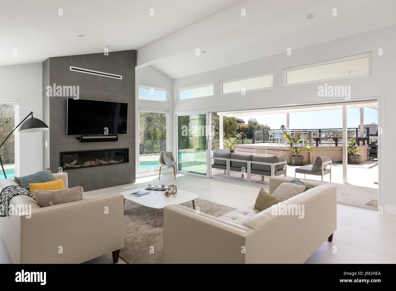 Modern living room with view to outdoor living area Stock Photo - Alamy