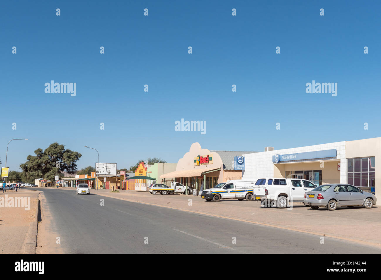 REHOBOTH, NAMIBIA - JUNE 14, 2017: A street scene with shops and cars ...
