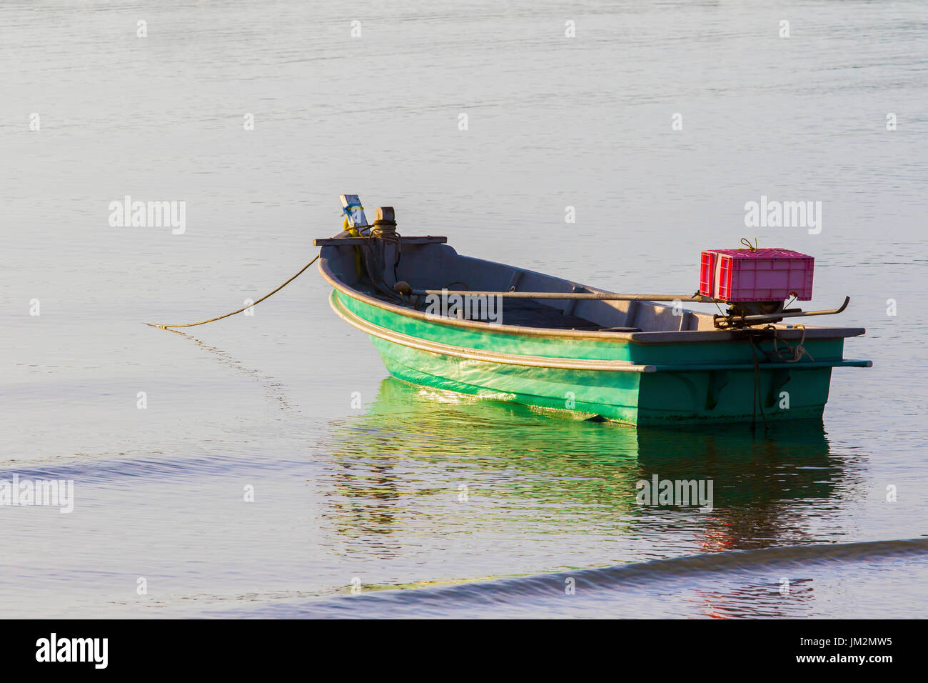lonely metal boat floating on sea beach Stock Photo - Alamy