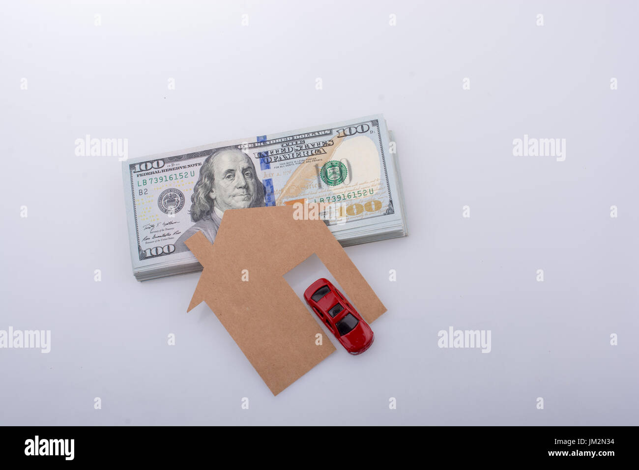 Paper house and a car beside US dollar banknotes Stock Photo - Alamy
