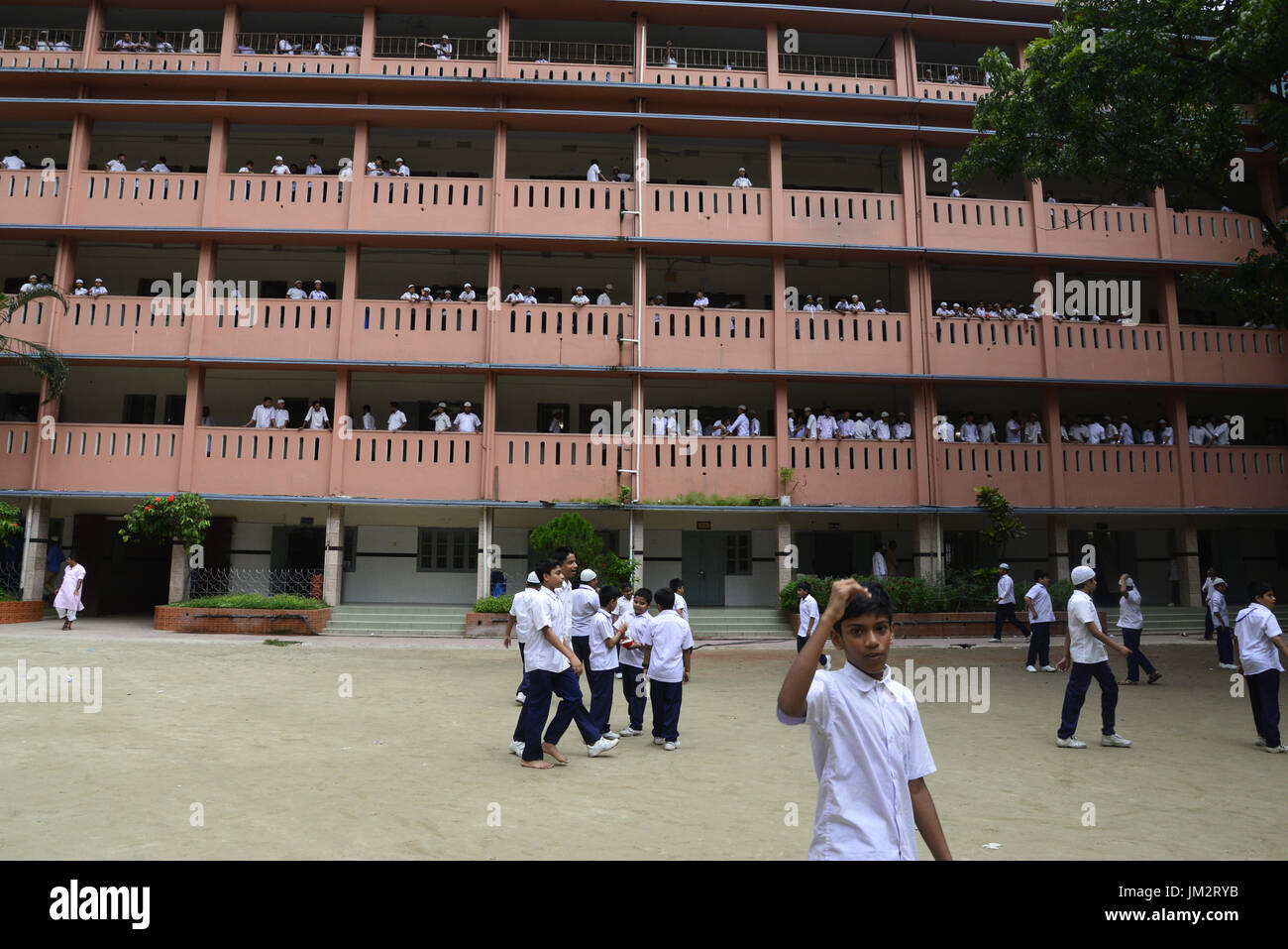 Bangladeshi school students walking on the school ground at class break ...