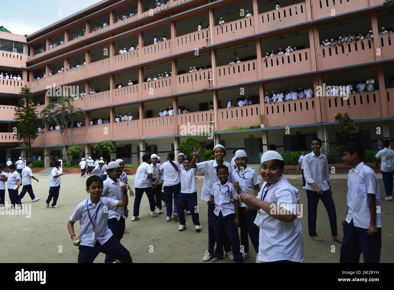 Bangladeshi school students walking on the school ground at class break ...