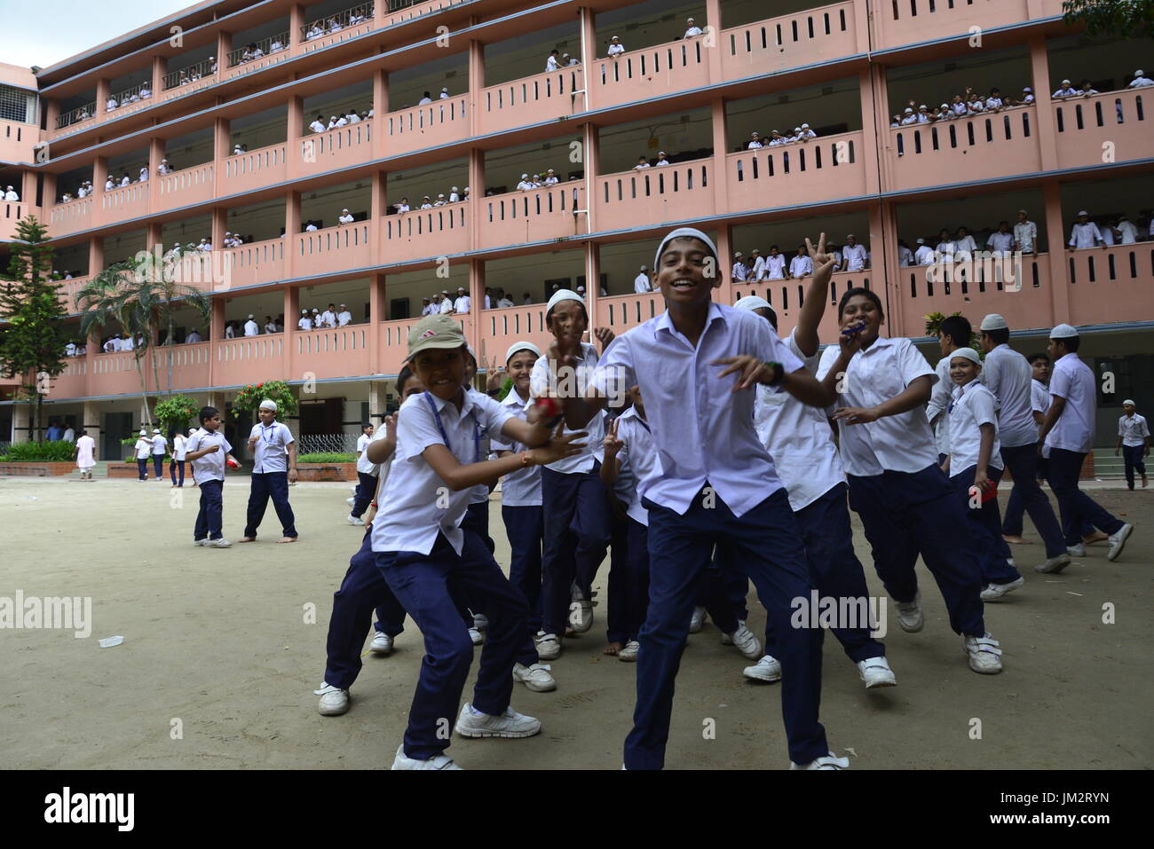 Bangladeshi school students walking on the school ground at class break ...