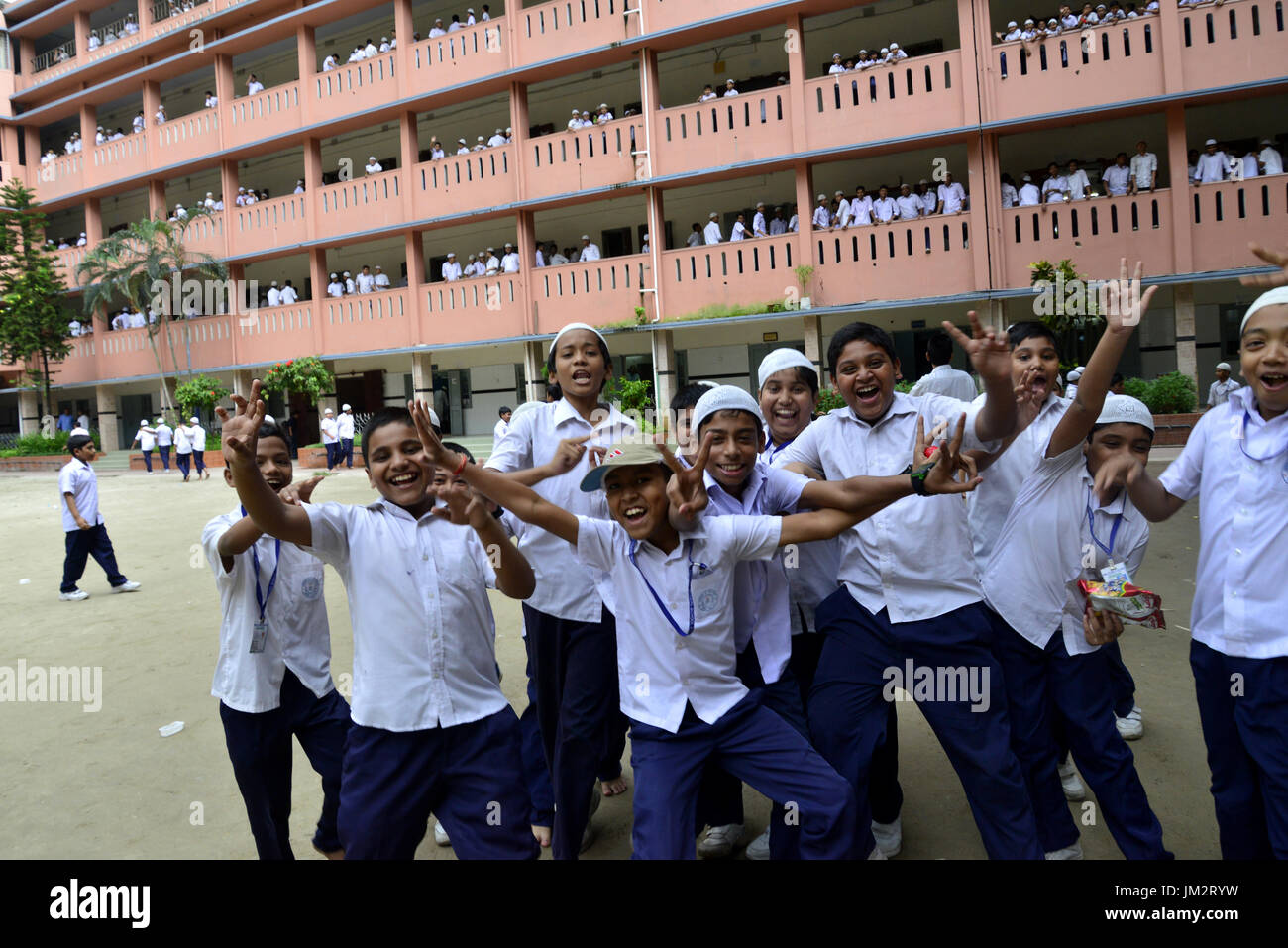 Bangladeshi school students walking on the school ground at class break ...