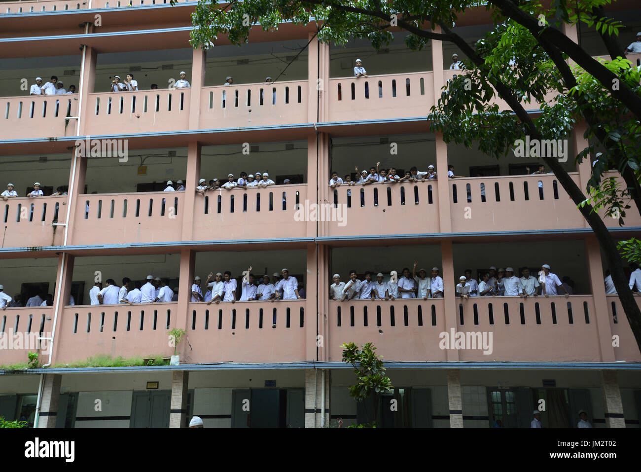 Bangladeshi school students walking on the school ground at class break ...