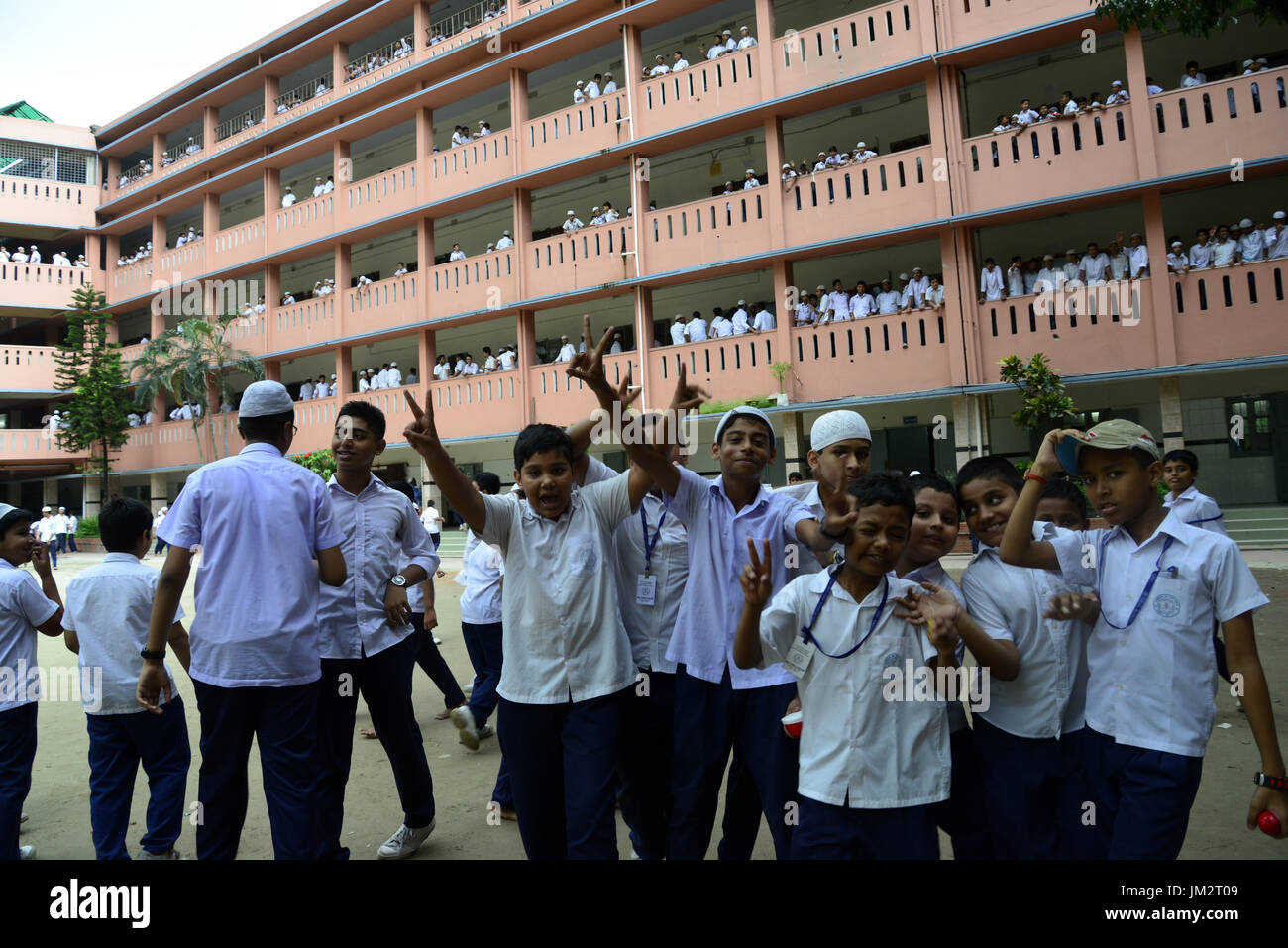 Bangladeshi school students walking on the school ground at class break ...