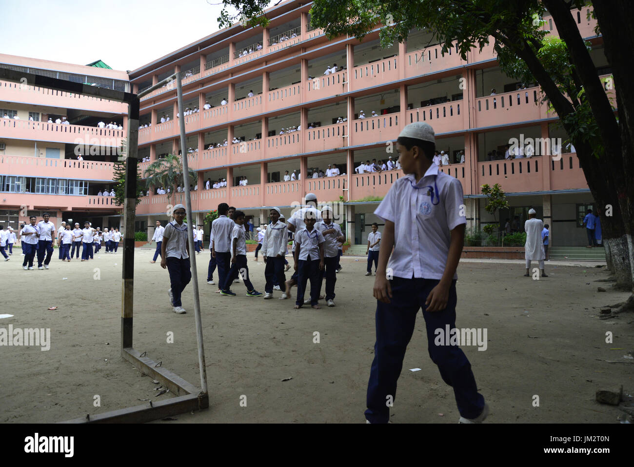 Bangladeshi school students walking on the school ground at class break ...