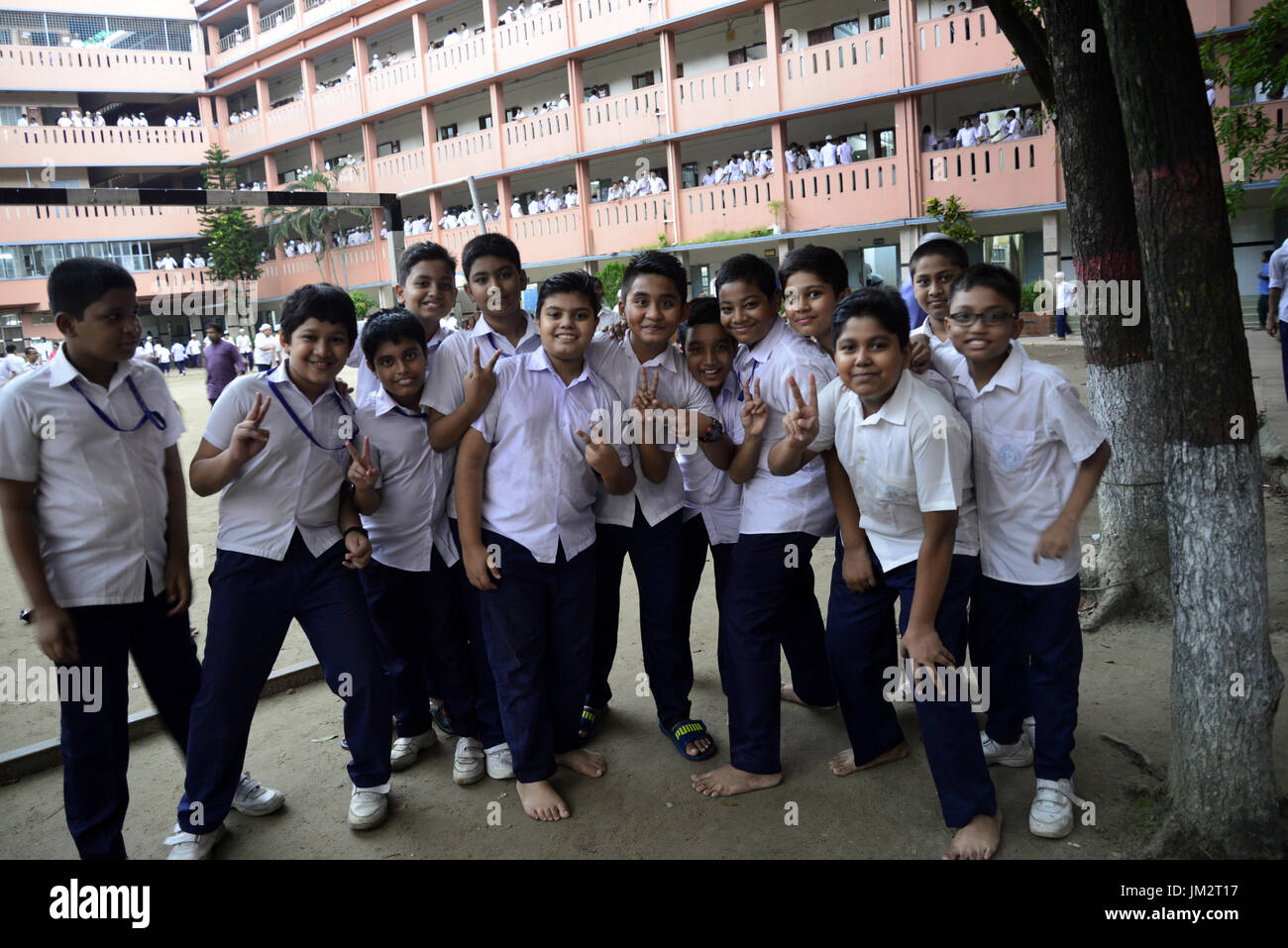 Bangladeshi school students walking on the school ground at class break ...