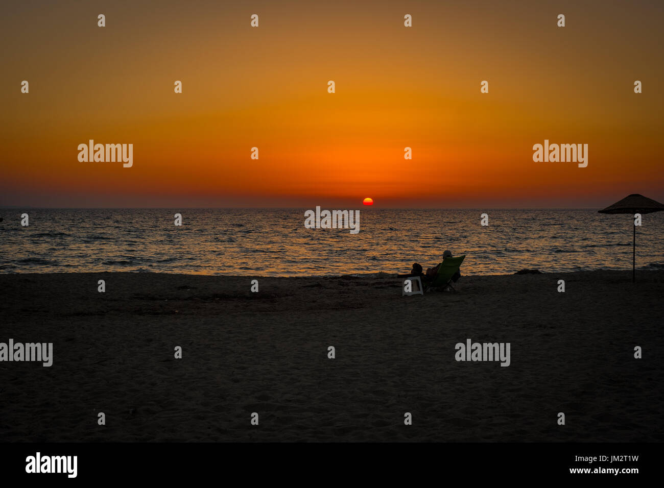Man sit on boat beach hi-res stock photography and images - Alamy