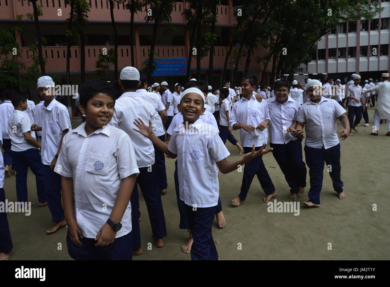 Bangladeshi school students walking on the school ground at class break ...