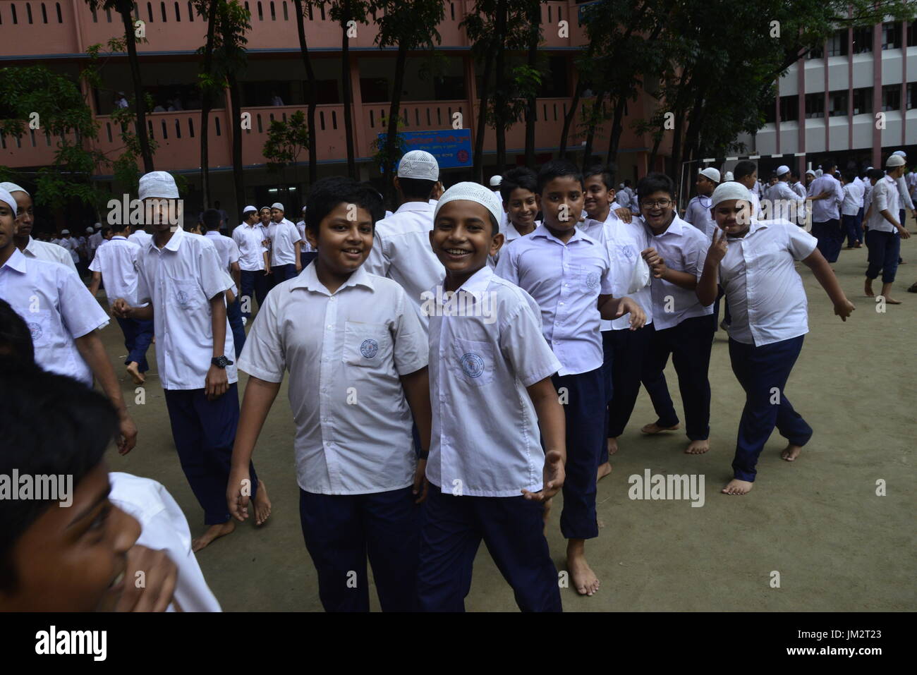 Bangladeshi school students walking on the school ground at class break ...