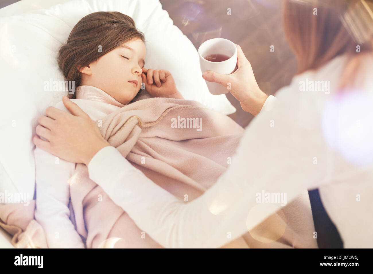 Careful mother bringing tea for her daughter Stock Photo - Alamy
