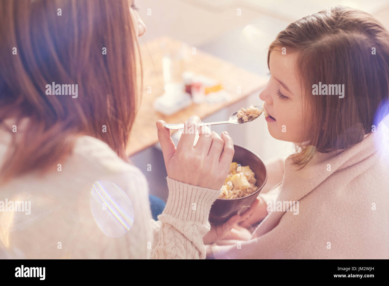 Sick kid feeling bad and cannot eat alone Stock Photo - Alamy