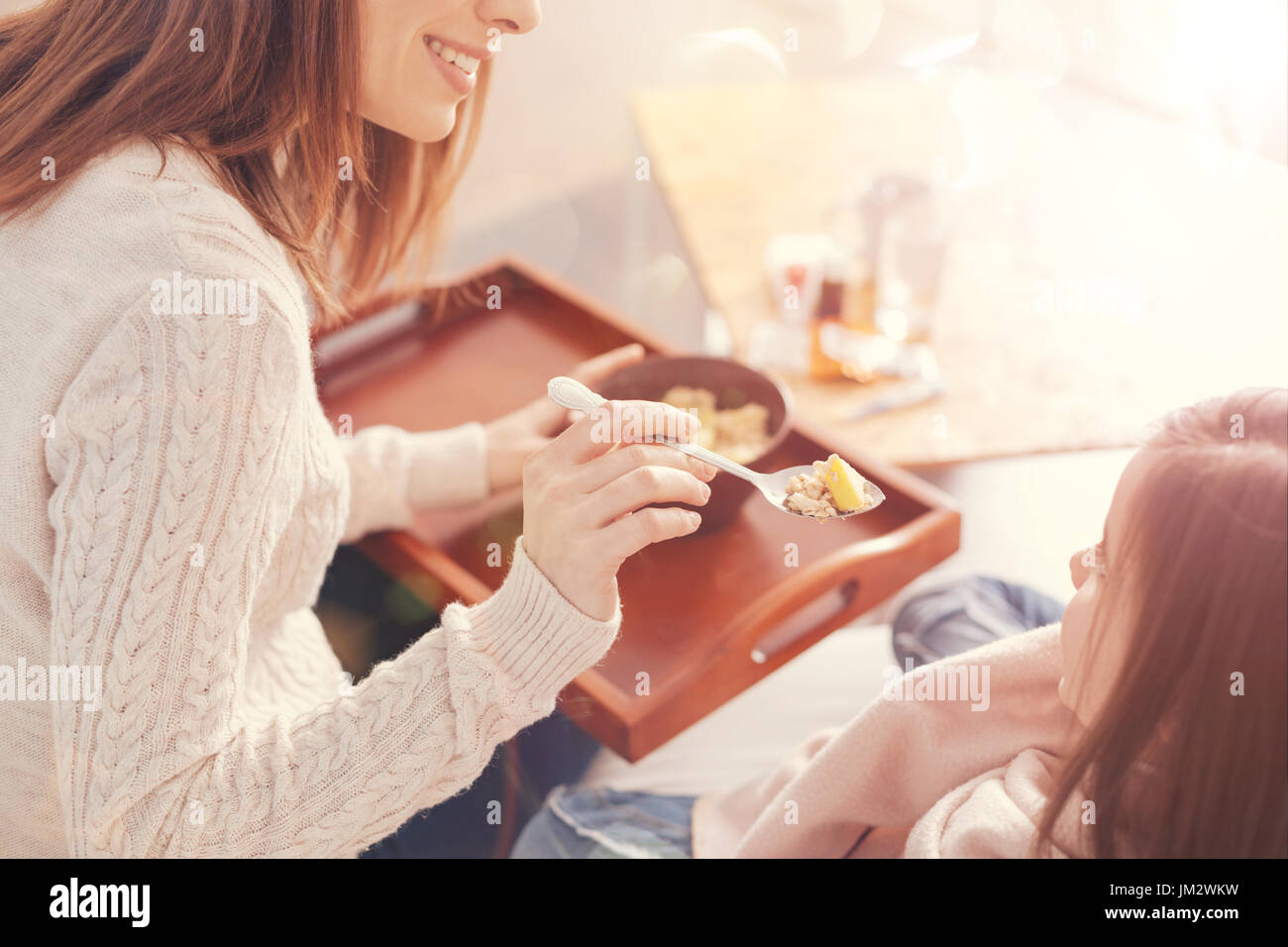 Positive delighted female holding spoon in right hand Stock Photo - Alamy