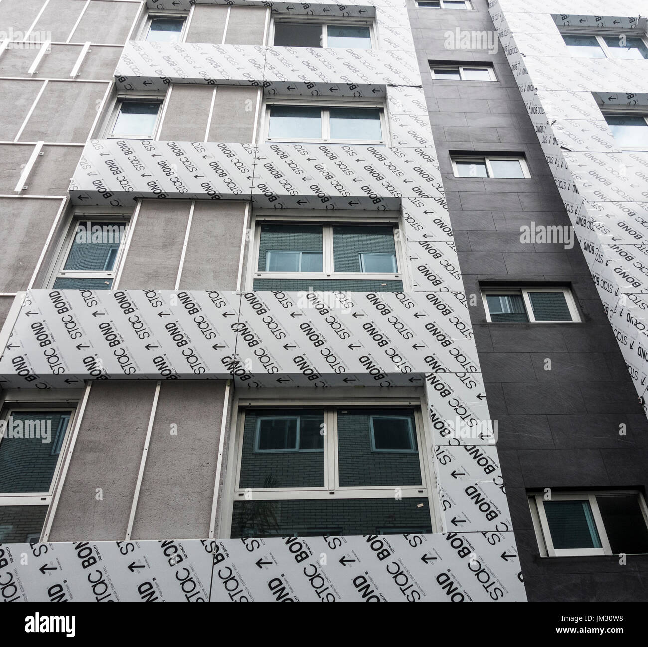 External cladding being fitted to new apartment block in Spain Stock ...