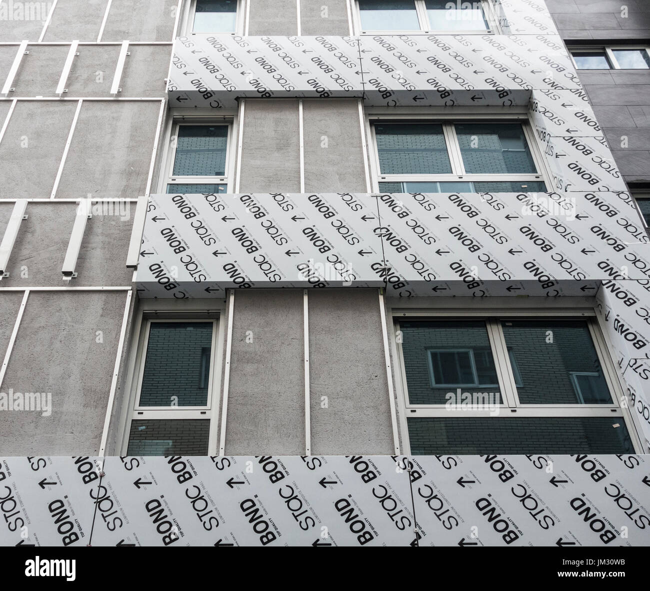 External cladding being fitted to new apartment block in Spain Stock ...