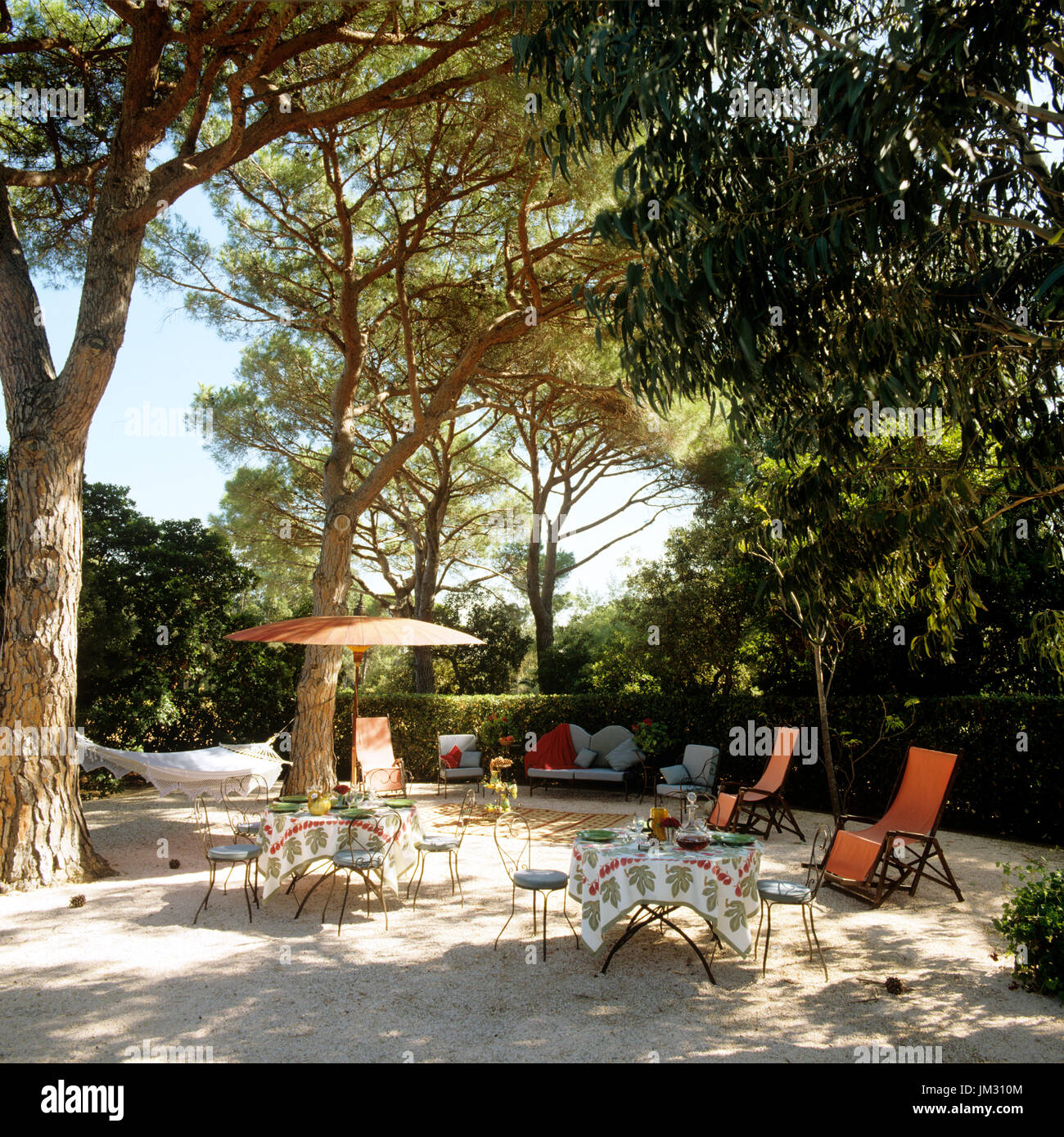 Outdoor chairs and tables in country style patio area Stock Photo - Alamy