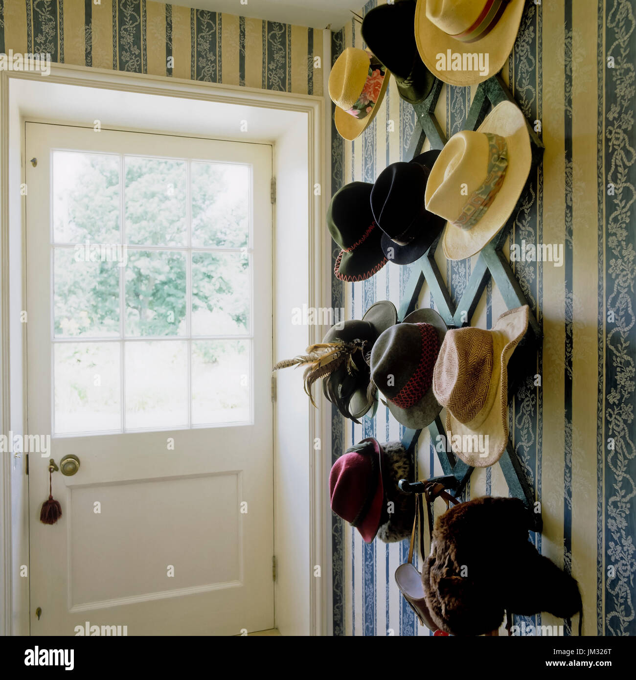 Hat rack by front door Stock Photo - Alamy