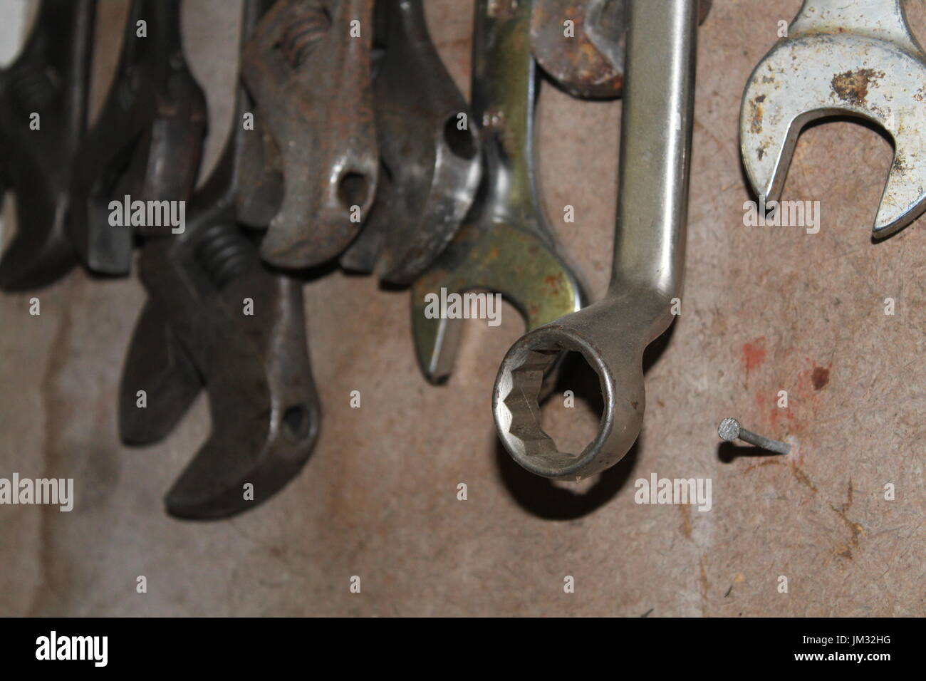 Different tools hanging in a shed Stock Photo - Alamy