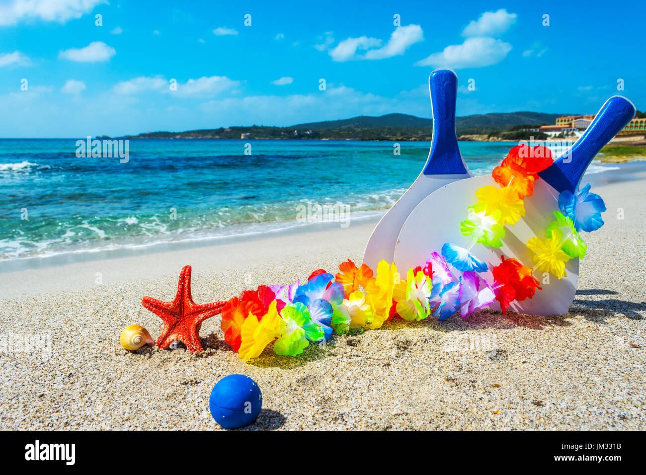 Rackets and sea star on the sand Stock Photo - Alamy
