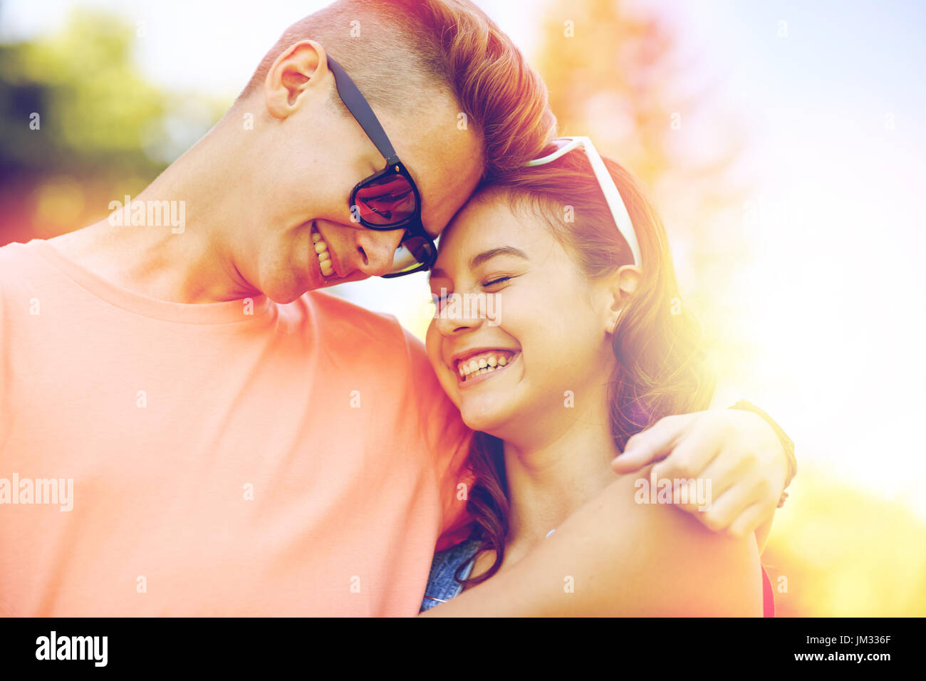 happy teenage couple hugging at summer Stock Photo - Alamy