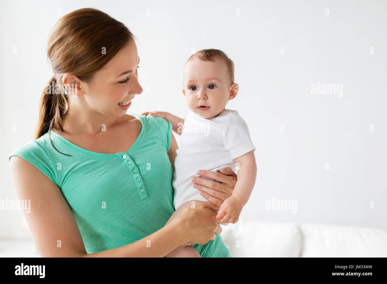 happy young mother with little baby at home Stock Photo - Alamy