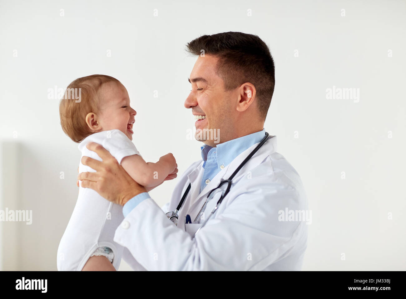 happy doctor or pediatrician with baby at clinic Stock Photo - Alamy