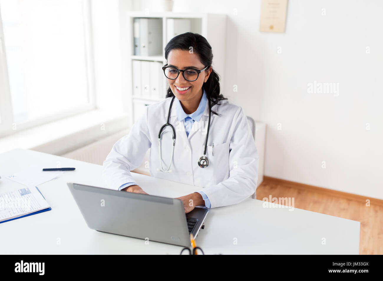 Beautiful smiling doctor typing hi-res stock photography and images - Alamy