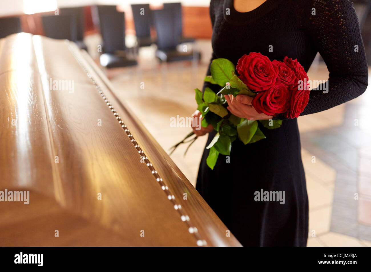 woman with red roses and coffin at funeral Stock Photo - Alamy