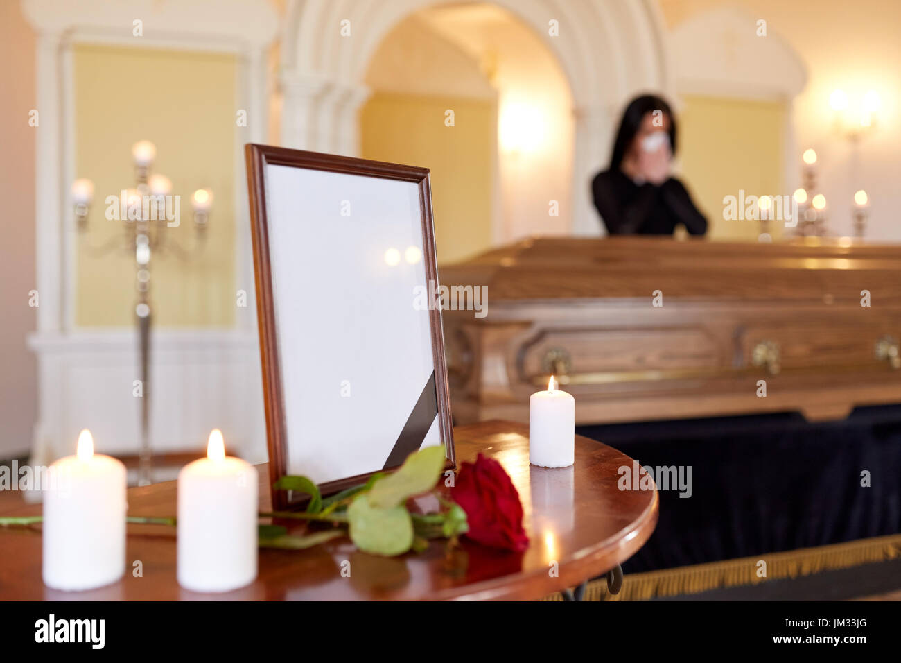 photo frame and woman crying at coffin at funeral Stock Photo - Alamy