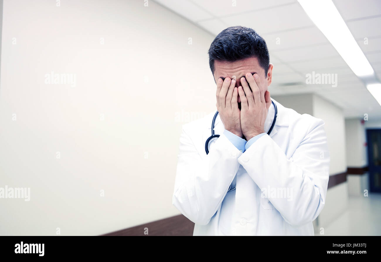 sad or crying male doctor at hospital corridor Stock Photo - Alamy