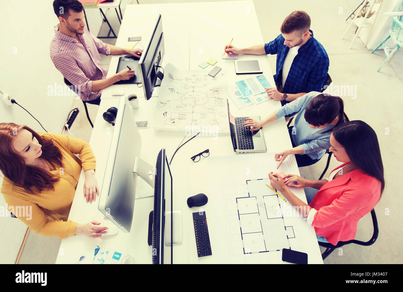 creative team with computers, blueprint at office Stock Photo - Alamy