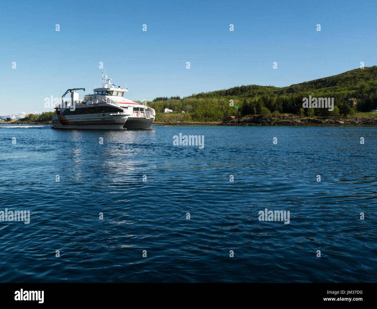Stjernoy catamaran sailing through narrow cut between the islands of ...