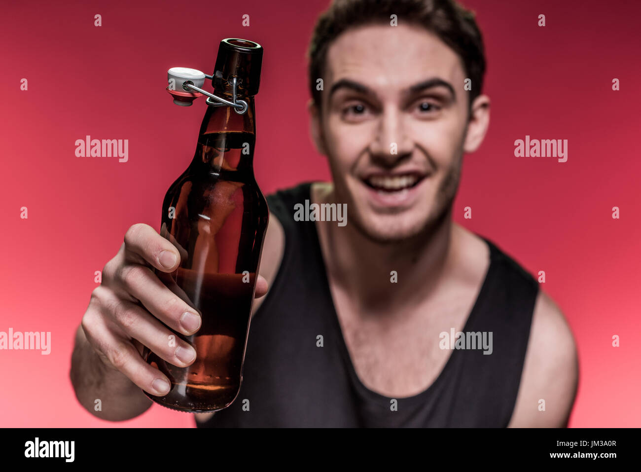 Man holding beer bottle hi-res stock photography and images - Alamy