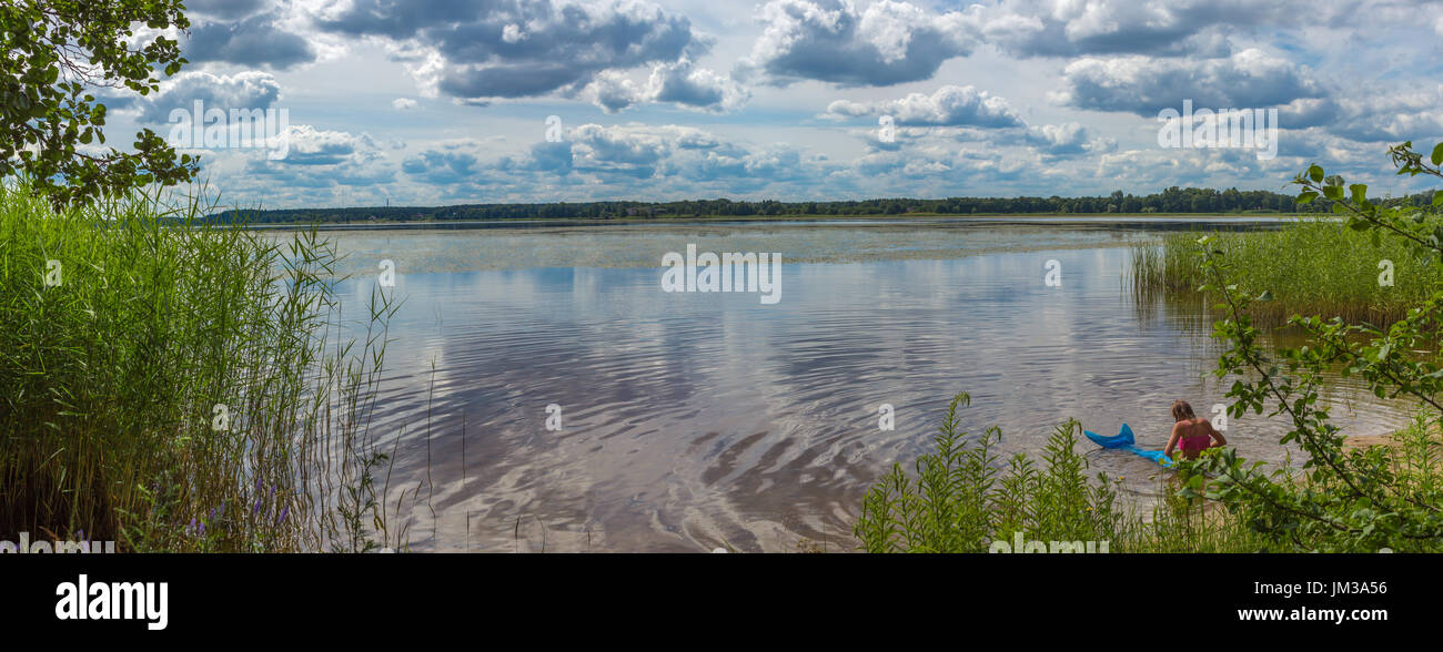 Panorama of lake Jugla in Latvia, Riga, little mermaid on the lake bank ...
