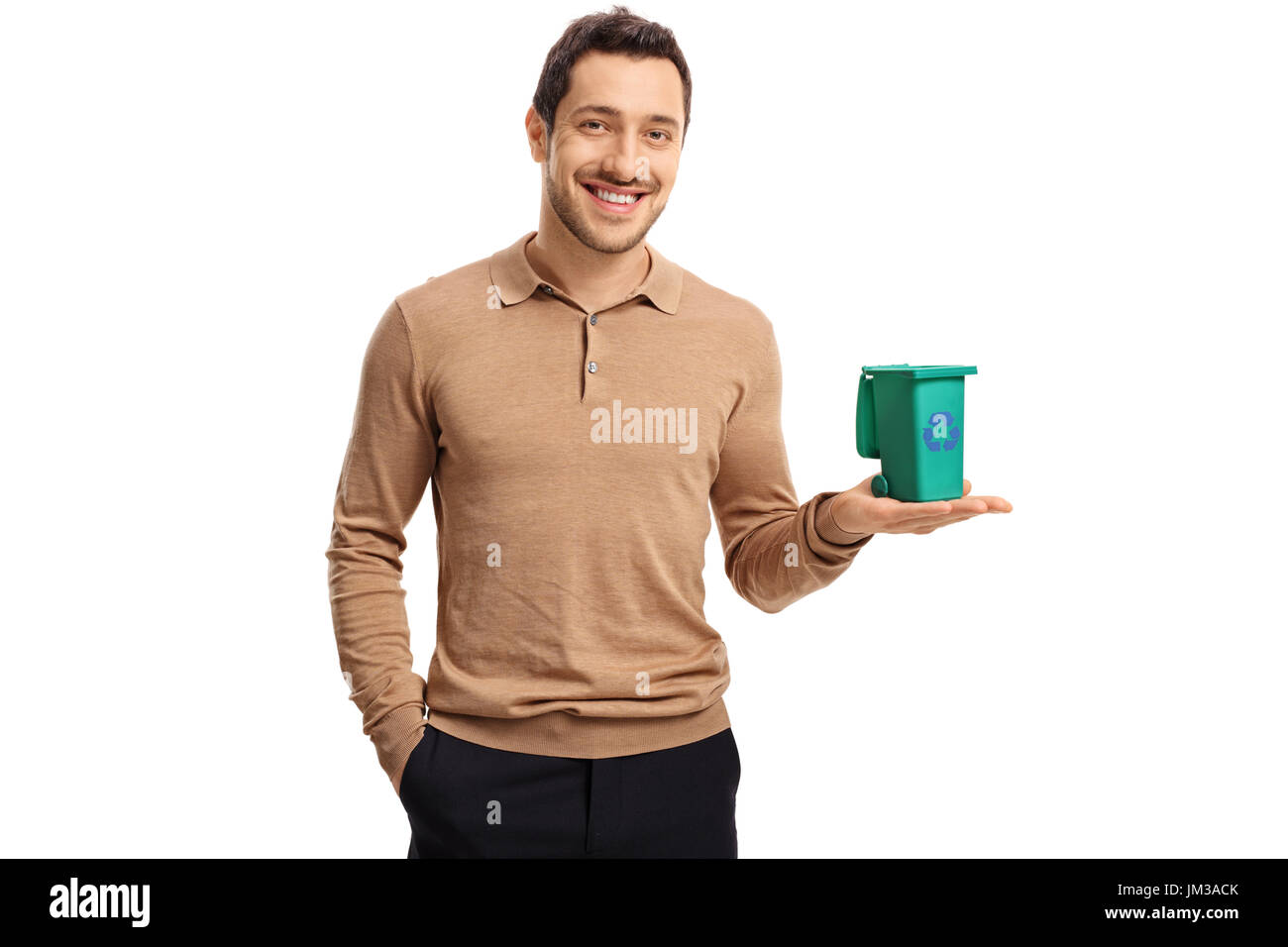 Young guy holding a small recycling bin and smiling isolated on white ...