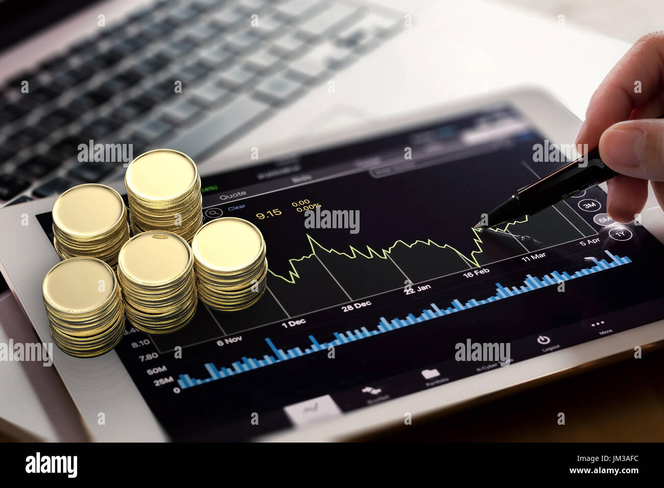 stock market watching with digital tablet and stack of gold coins Stock ...