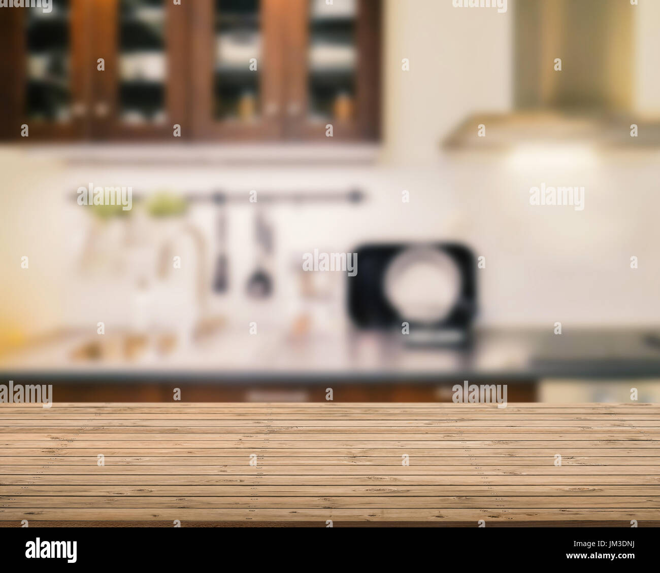 wooden counter top with kitchen blurred background Stock Photo - Alamy