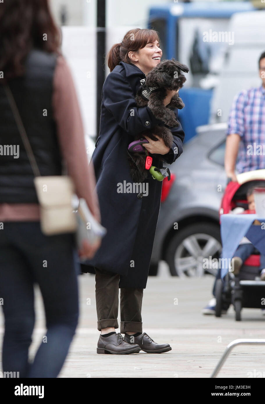 Anna Friel with a dog during a break from filming scenes on location ...