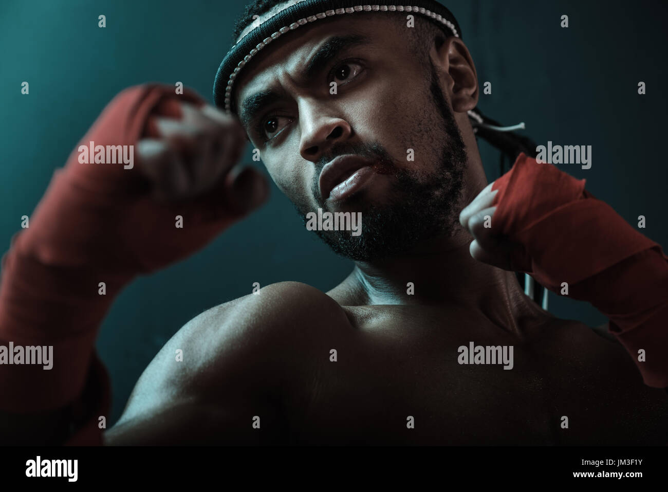 Close-up portrait of aggressive young Muay thai boxer training thai ...