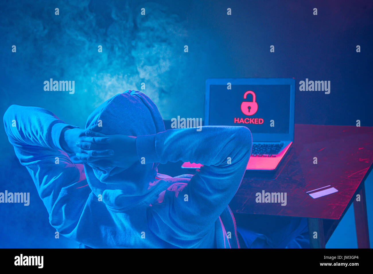 Hooded computer hacker stealing information with laptop Stock Photo - Alamy