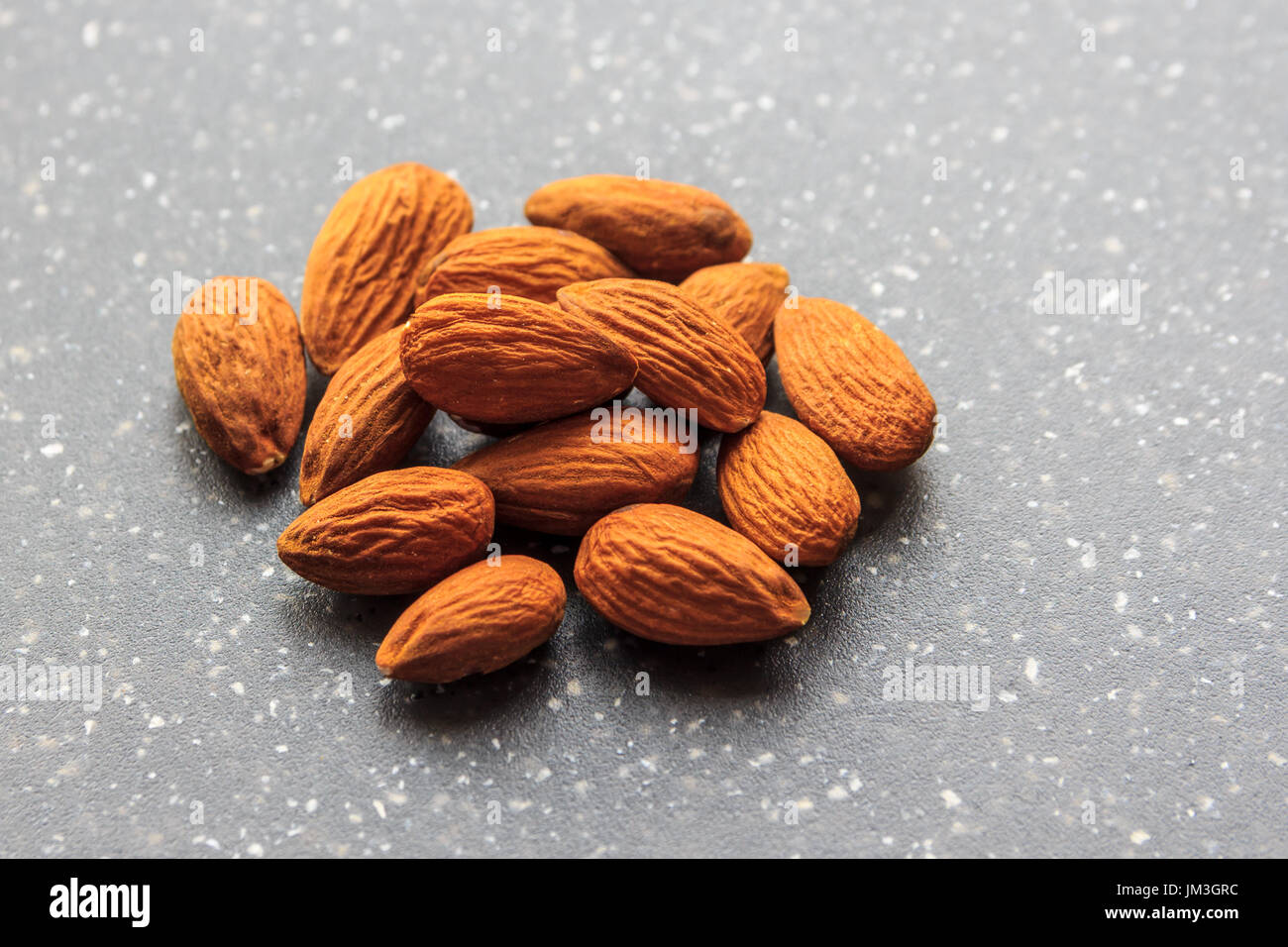 almonds in pile on granite background Stock Photo - Alamy