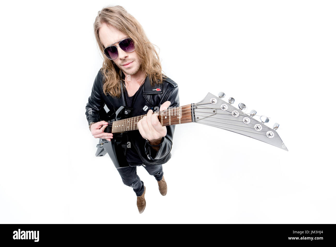 handsome rocker in sunglasses posing playing electric guitar isolated ...