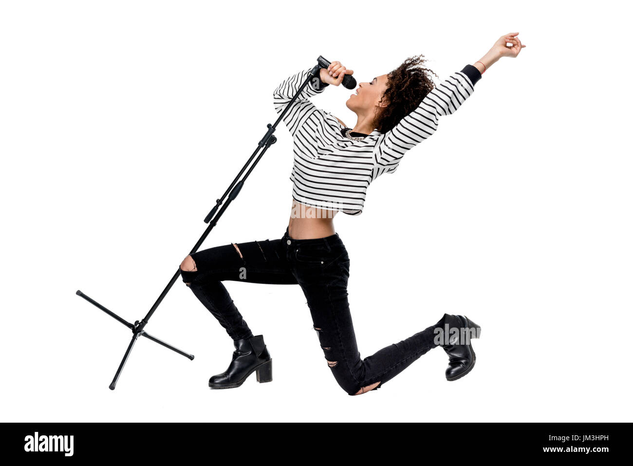 Beautiful young emotional heavy metal singer with microphone singing ...