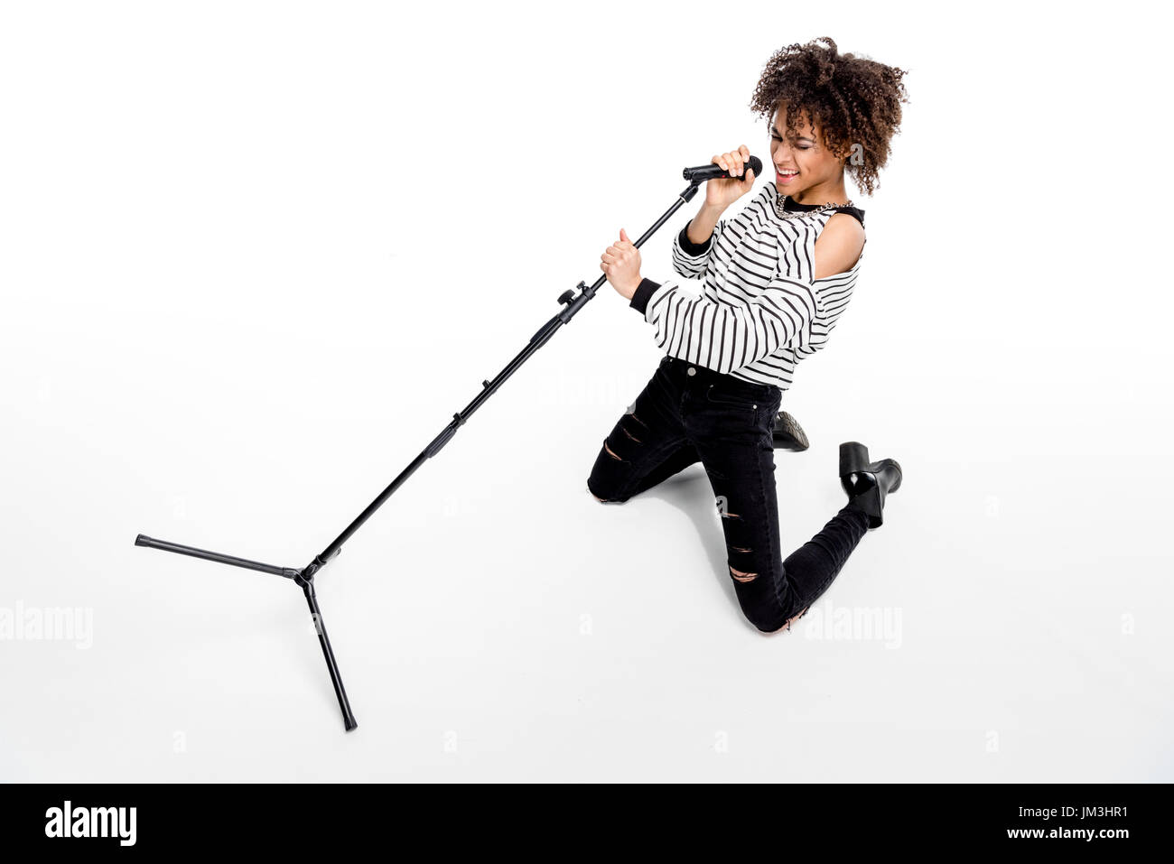 Beautiful young emotional heavy metal singer with microphone singing ...