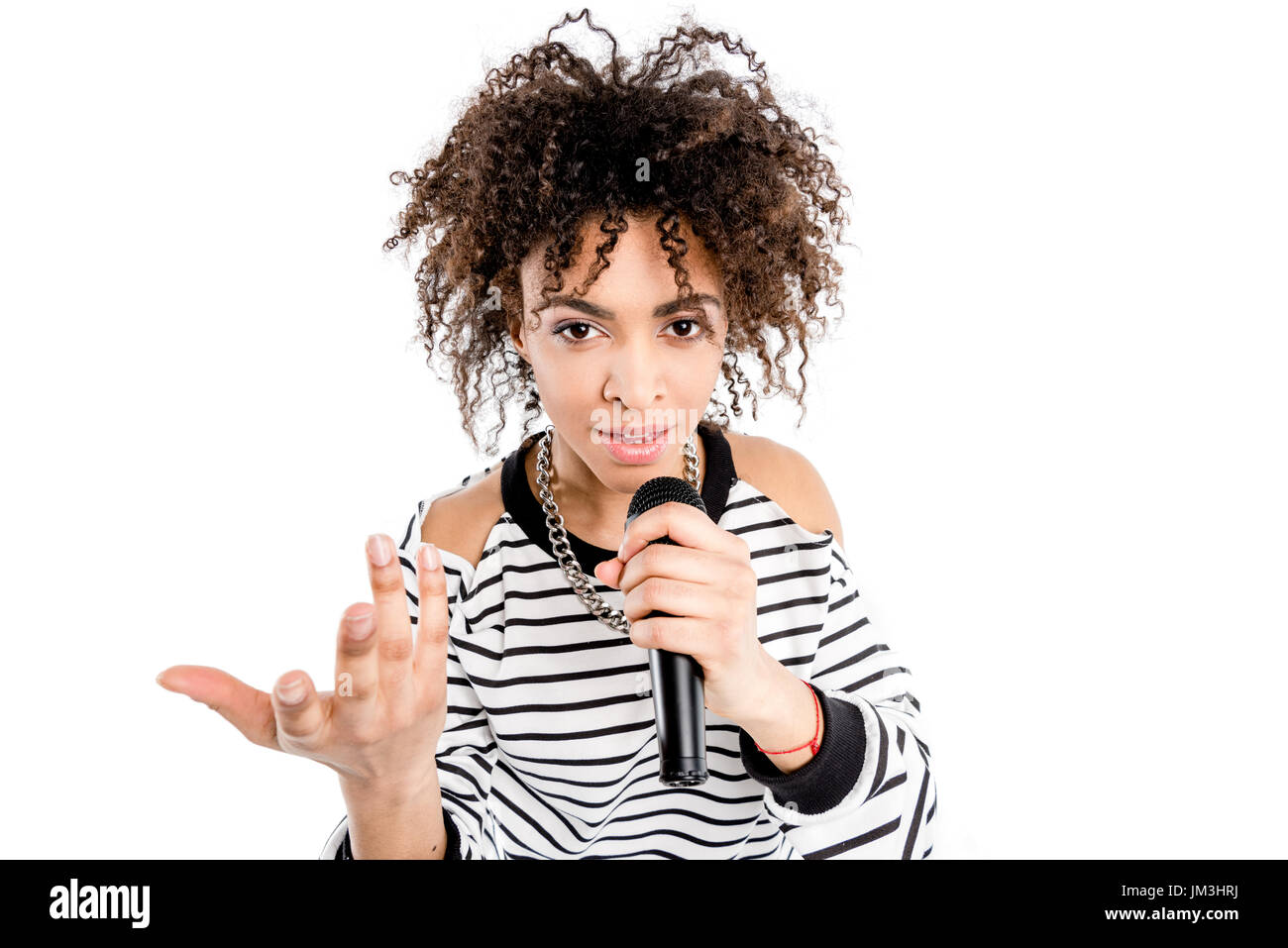 Beautiful young heavy metal singer with microphone singing and ...