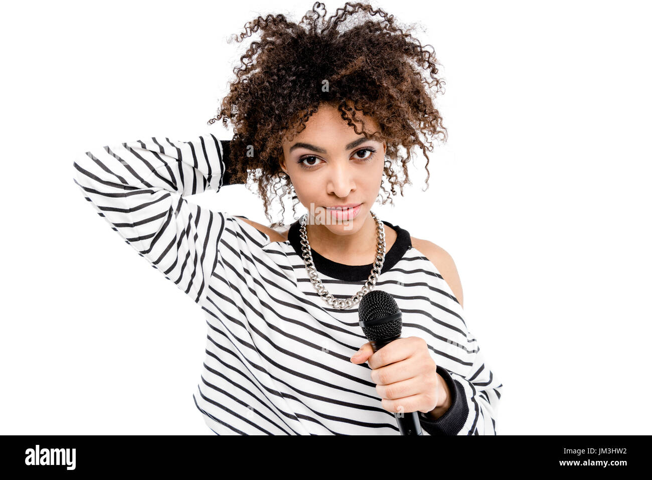 Attractive young heavy metal singer holding microphone and smiling at ...