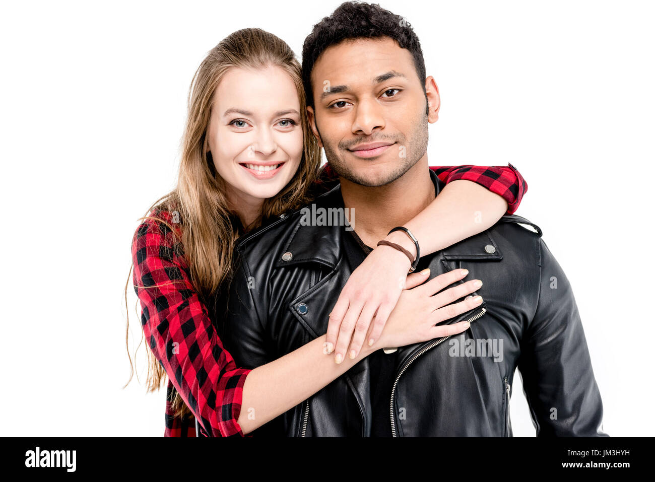 Smiling young woman hugging handsome man in leather jacket isolated on ...