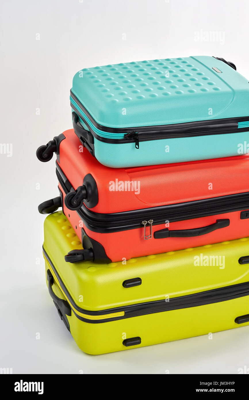 Row of different wheeled suitcases. Colorful luggages close up Stock ...