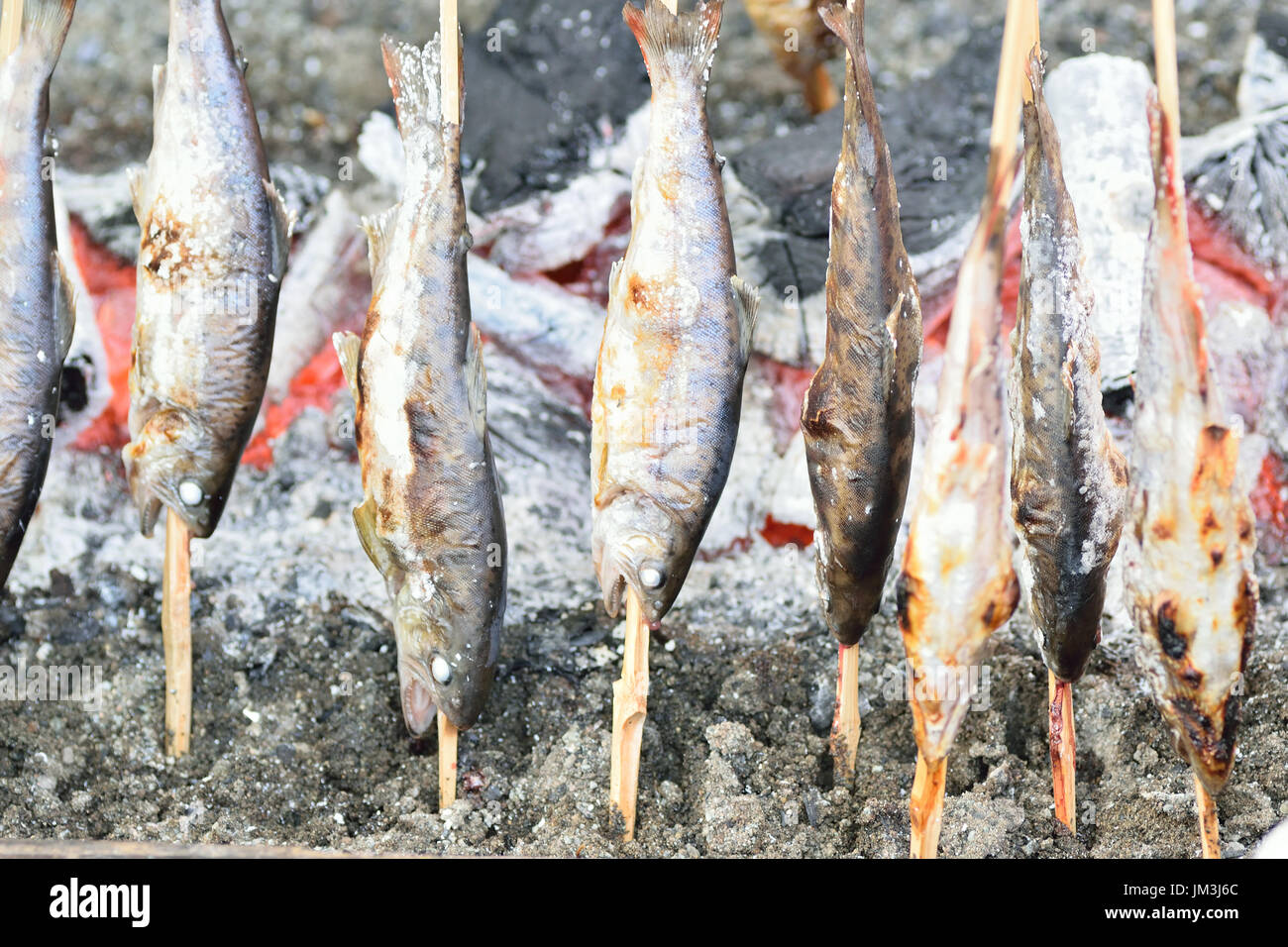 Japanese street food Grilled Ayu fish in horizontal frame Stock Photo ...